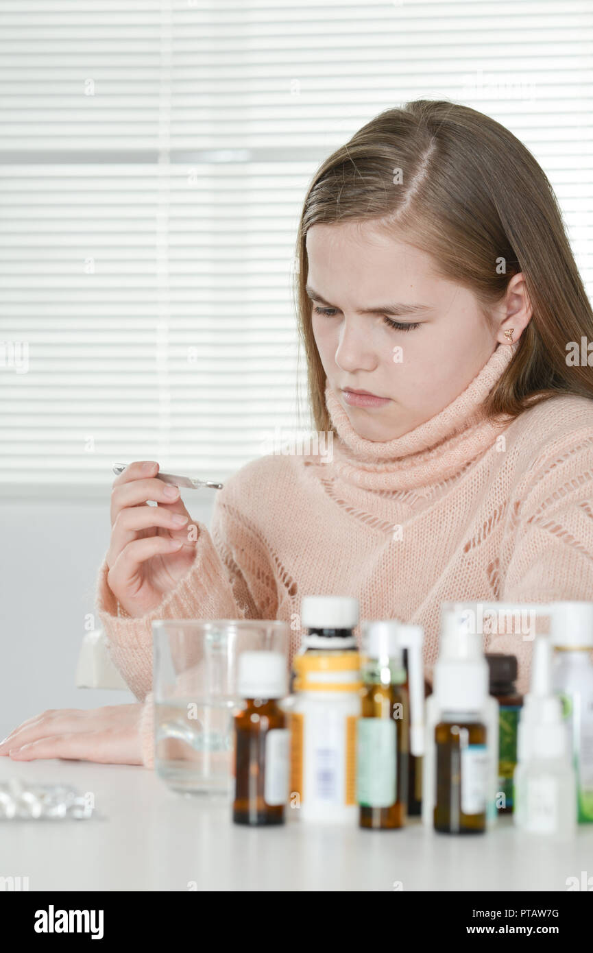 Portrait of a cute little girl taking medicine at home Stock Photo - Alamy