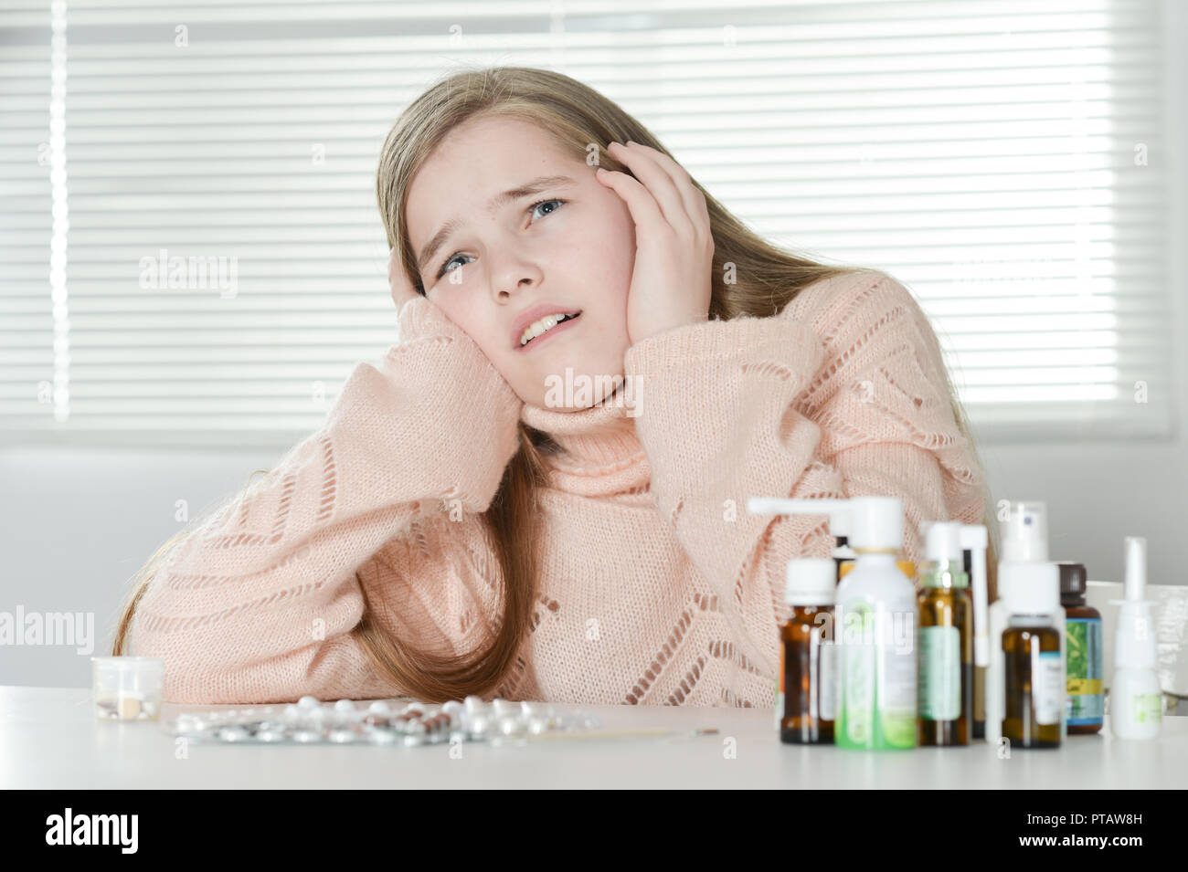Portrait of a cute little girl taking medicine at home Stock Photo - Alamy