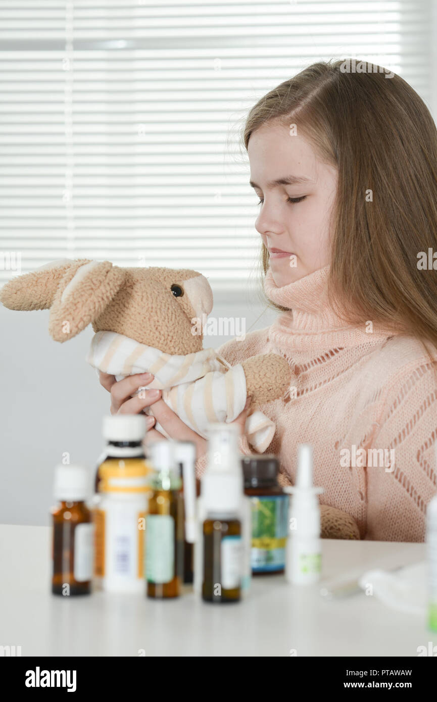 Portrait of a cute little girl taking medicine at home Stock Photo - Alamy