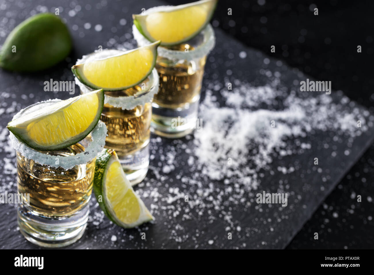 Golden tequila on a black background. Alcoholic cocktail. Mexican ...