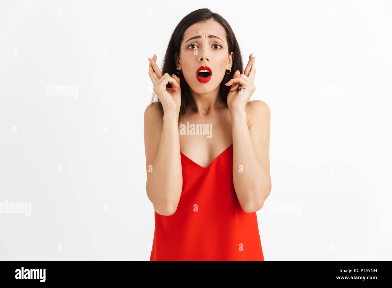 Image of nervous hopeful young beautiful woman posing isolated Stock ...