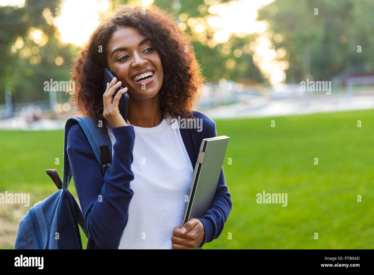 Image of young beautiful african woman student walking in the park ...
