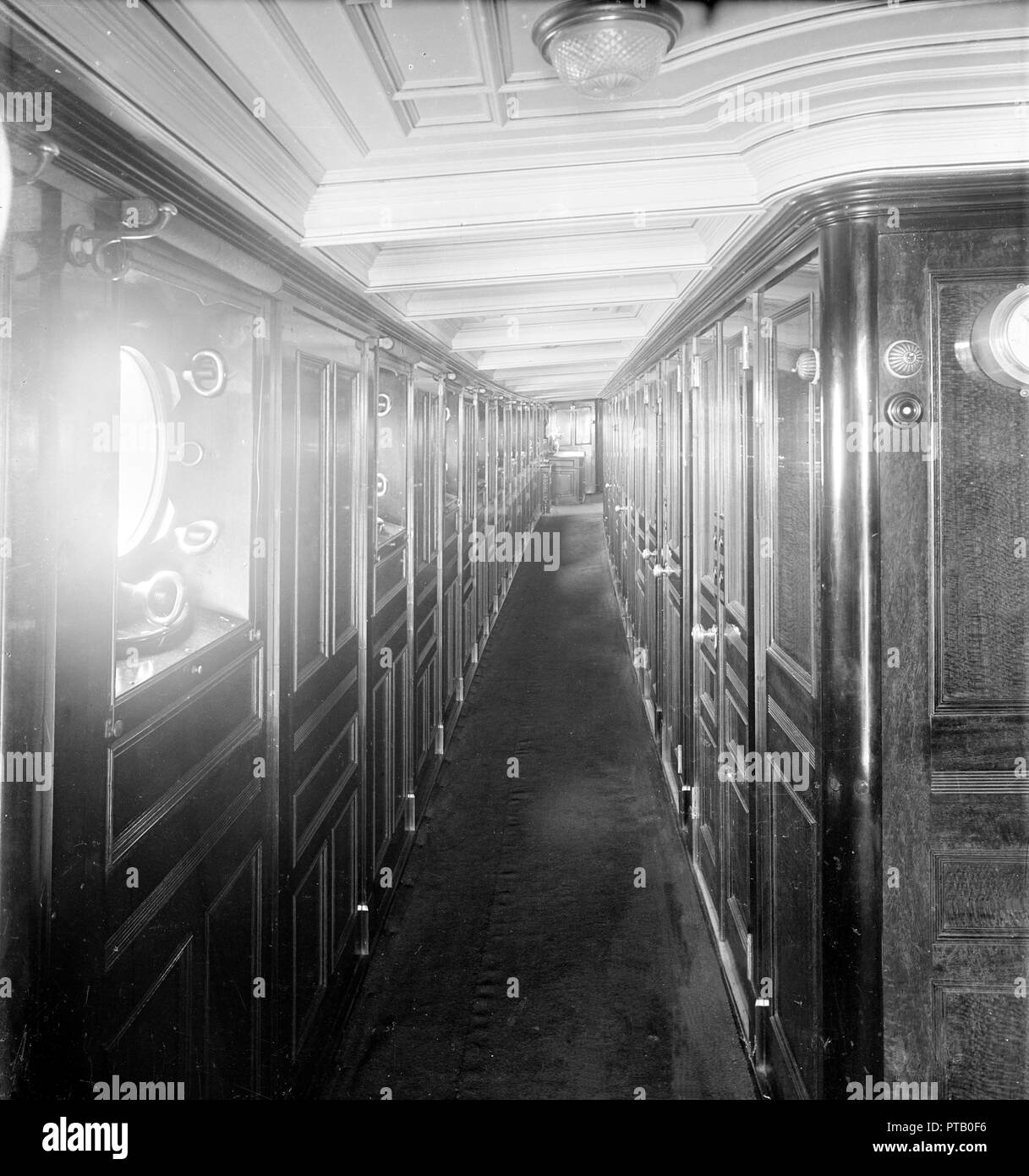Long wood panelled corridor on steam yacht 'Venetia', 1920. Creator ...
