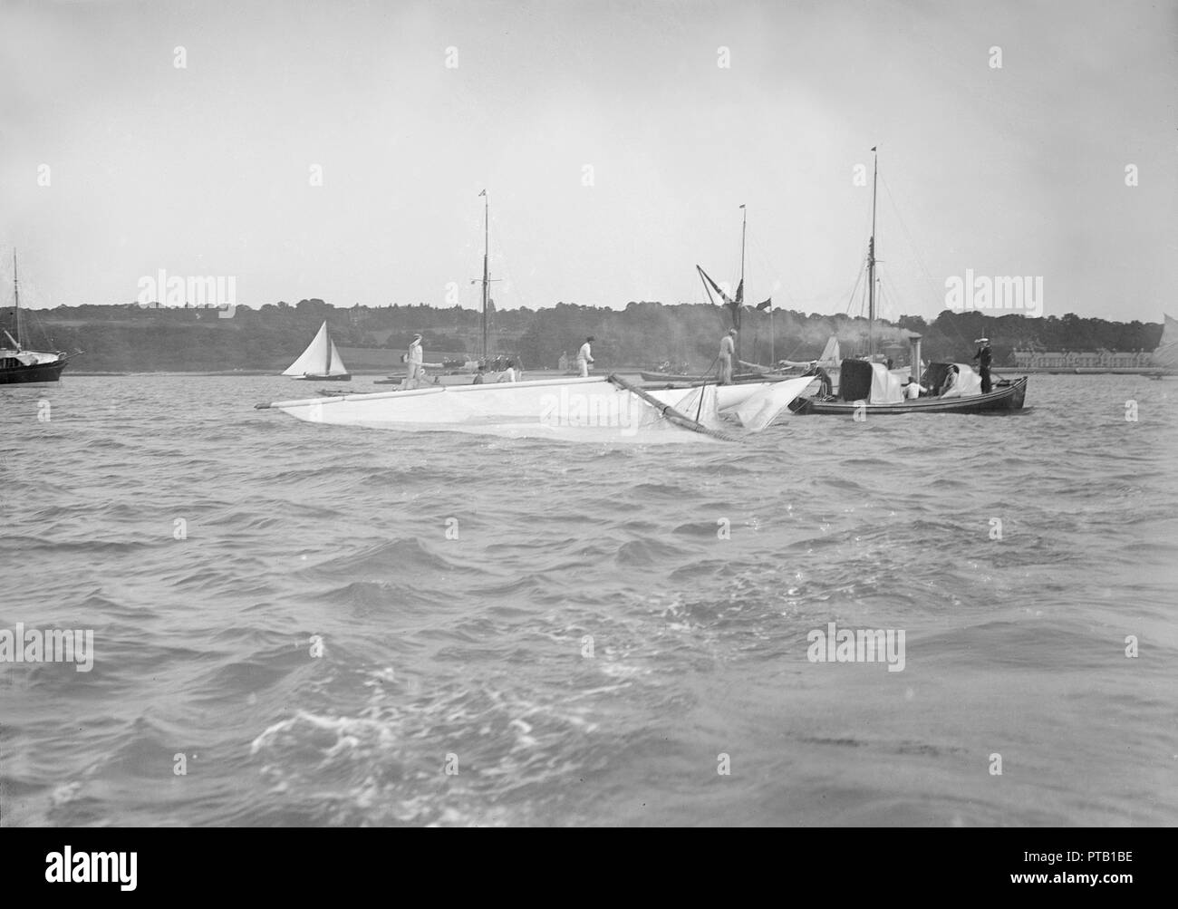 The dismasted sailing yacht 'Clio' is attended to by rescue boats, 1912 ...