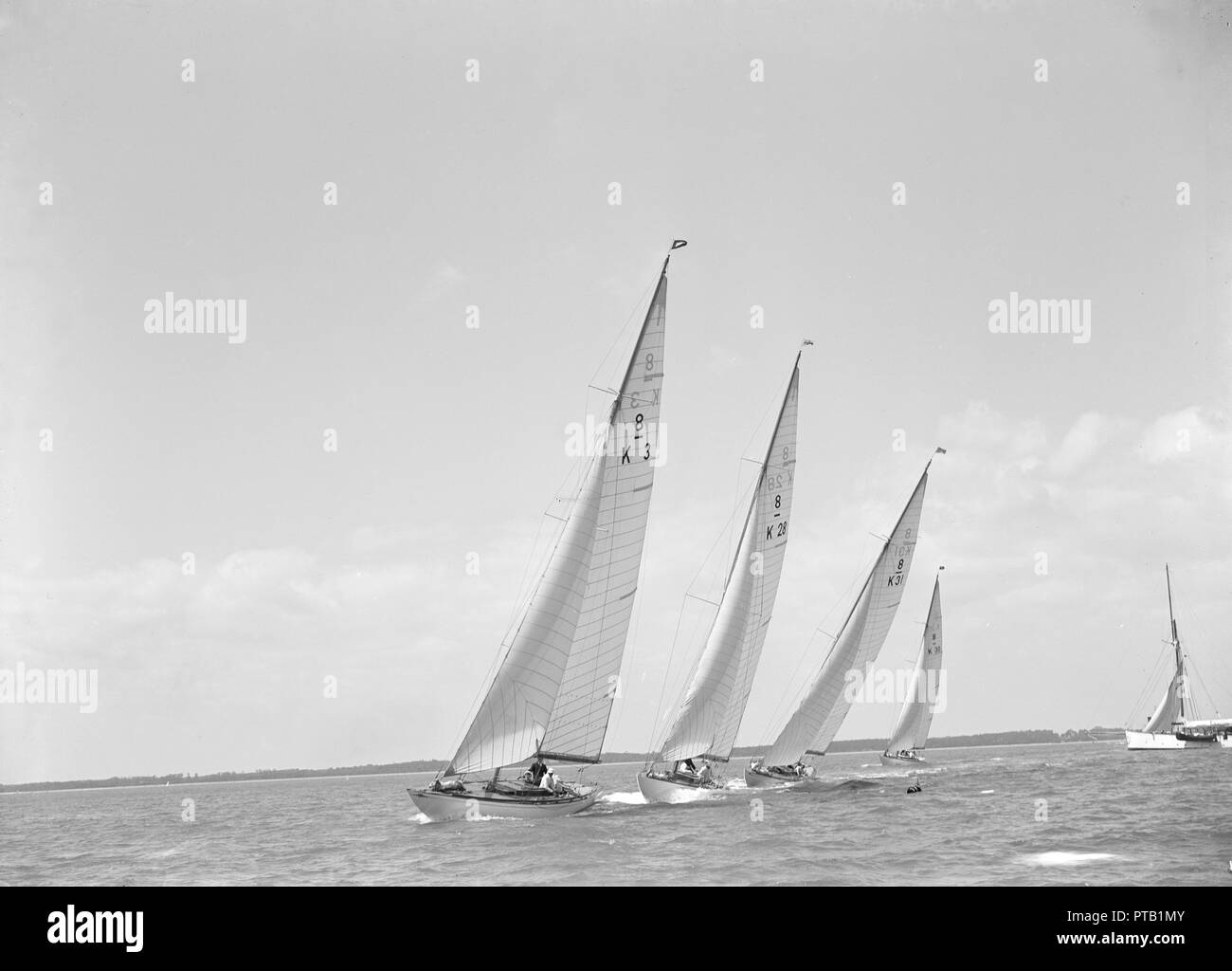 Group of 8 Metre sailing yachts racing close-hauled. Creator: Kirk ...