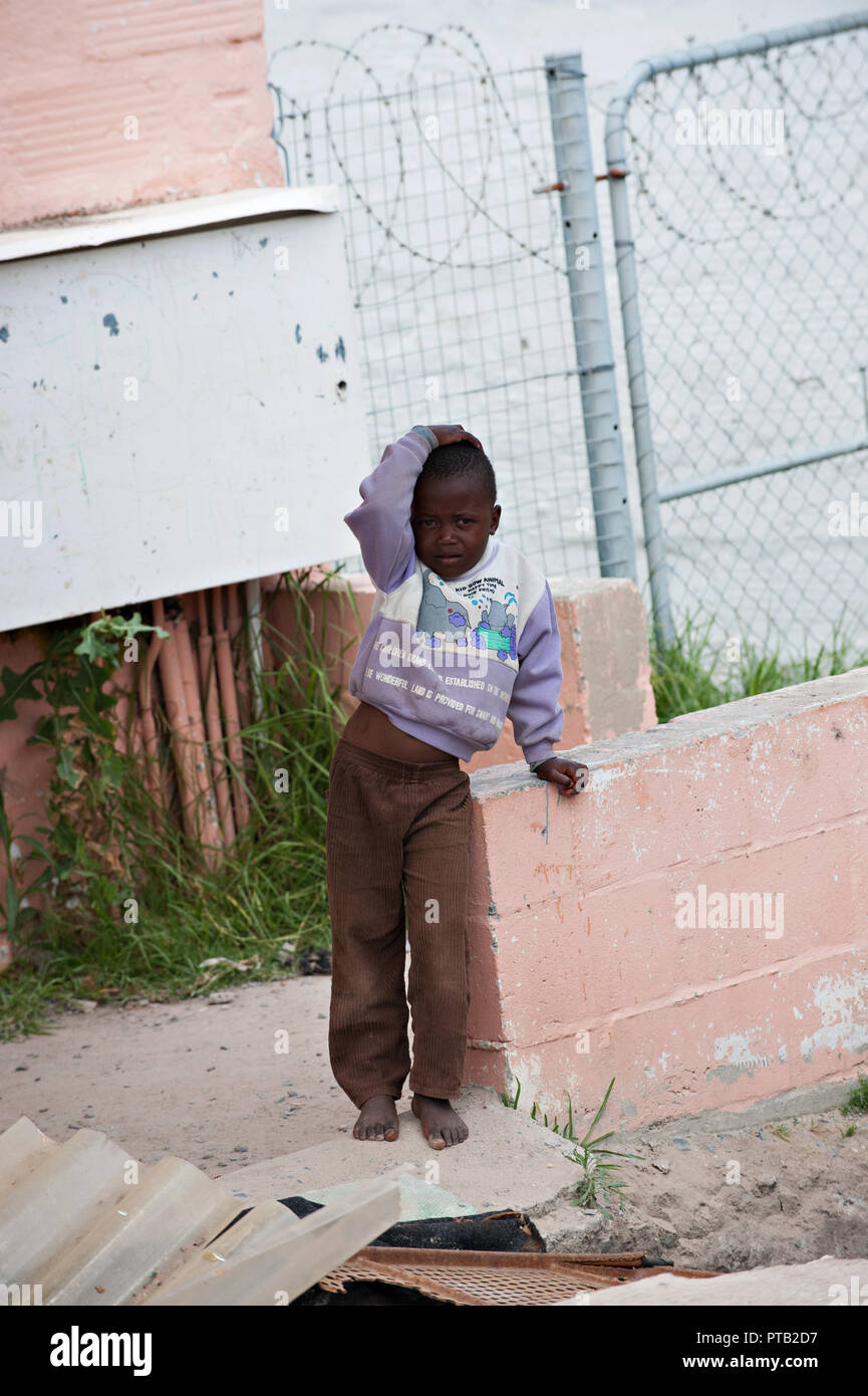 A young boy without shoes in the township village of Imizamo Yethu a ...