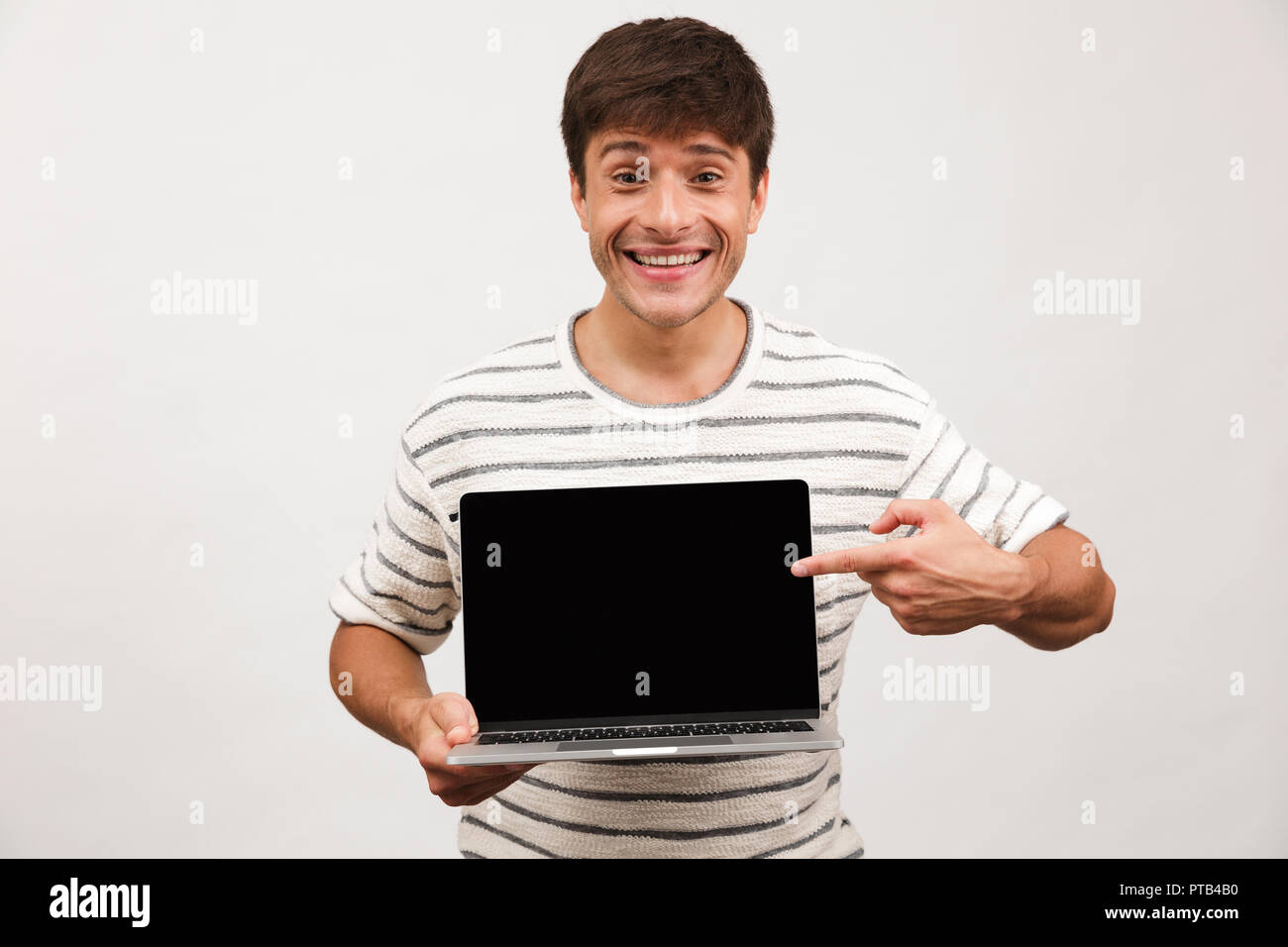 Image of excited man standing isolated over white background using ...