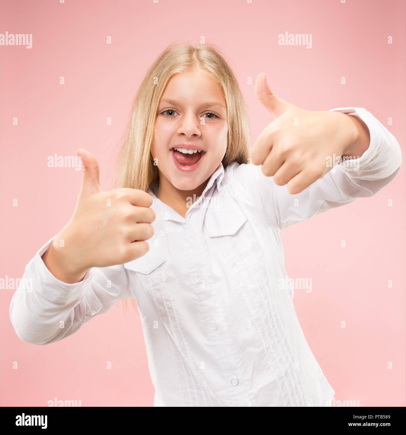Happy teen girl standing, smiling isolated on trendy pink studio ...