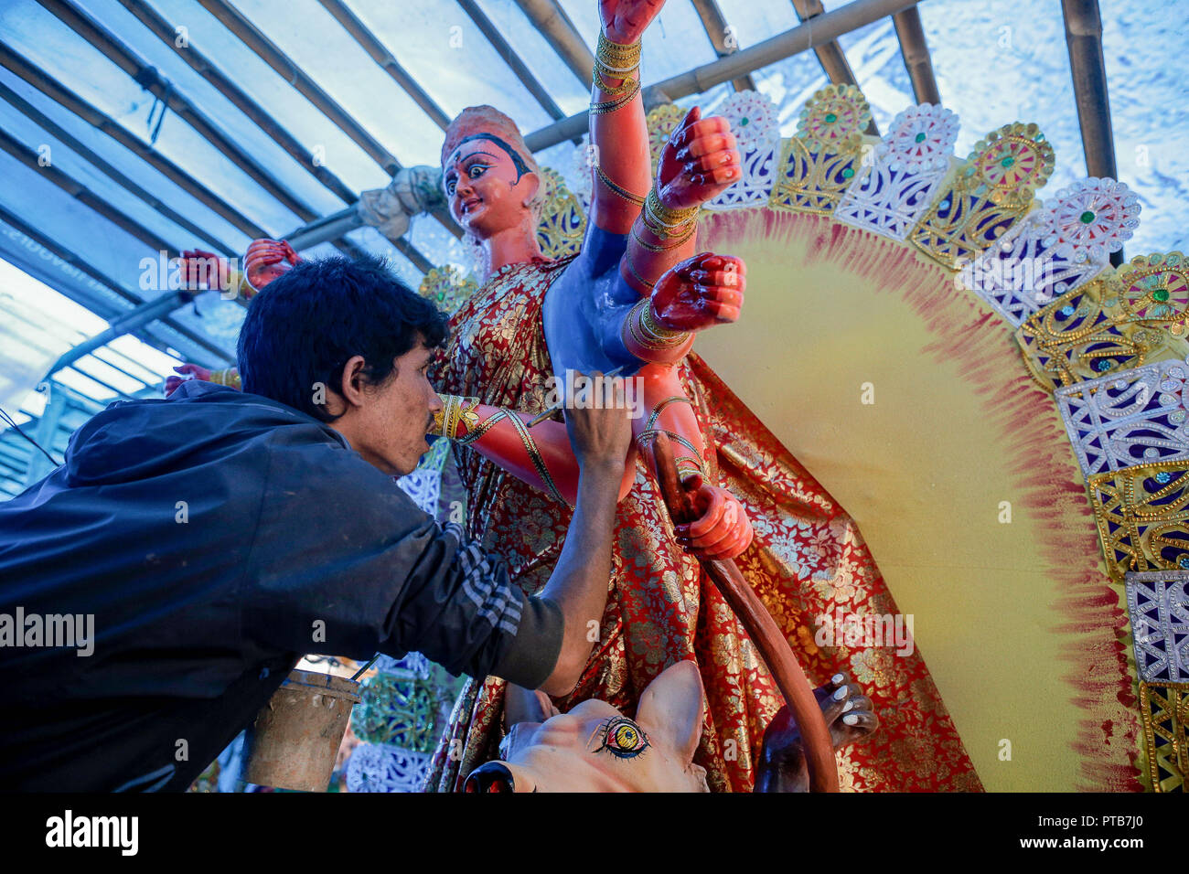 An artist decorates an idol of Hindu Goddess Durga, the matriarch of ...