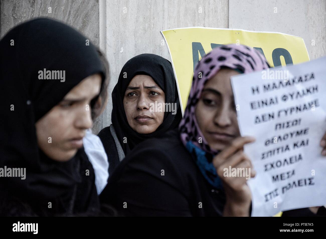 Women seen holding placard outside of the Ministry of Migration Policy ...