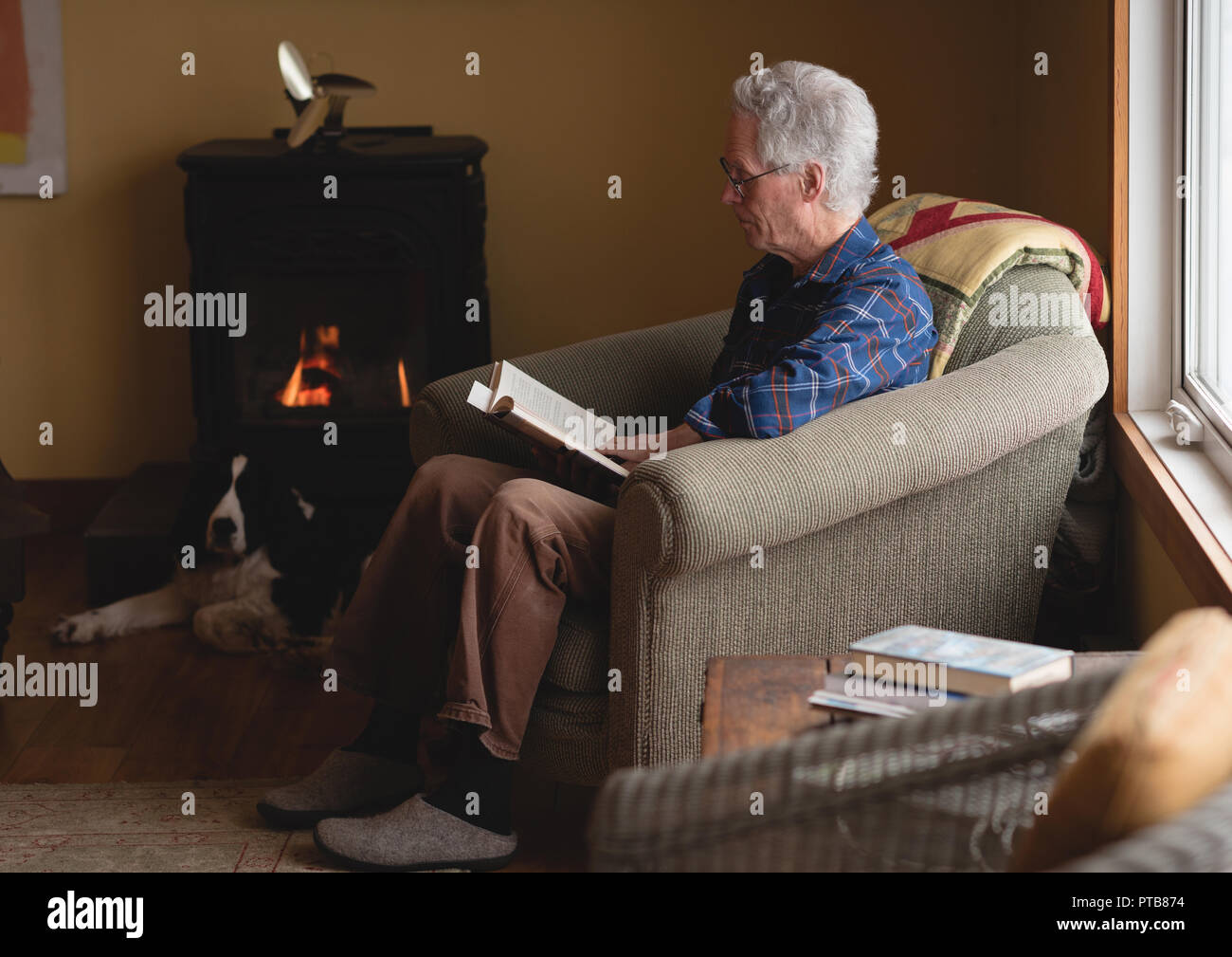 Book on arm of chair hi-res stock photography and images - Alamy