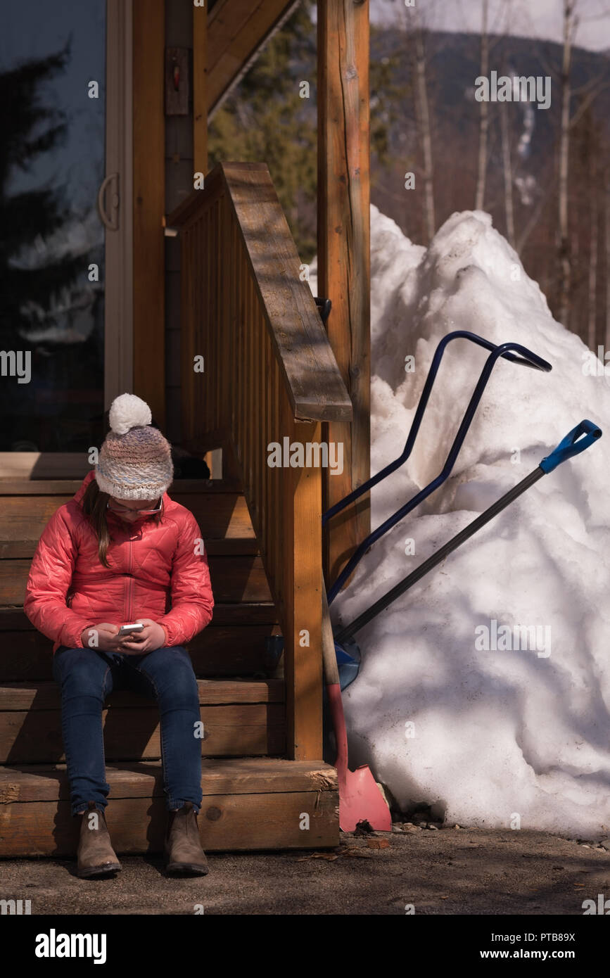 Girl using mobile phone during winter Stock Photo - Alamy