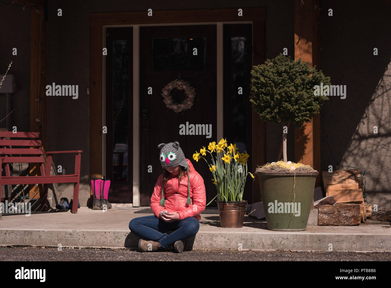 Girl using mobile phone near street Stock Photo - Alamy