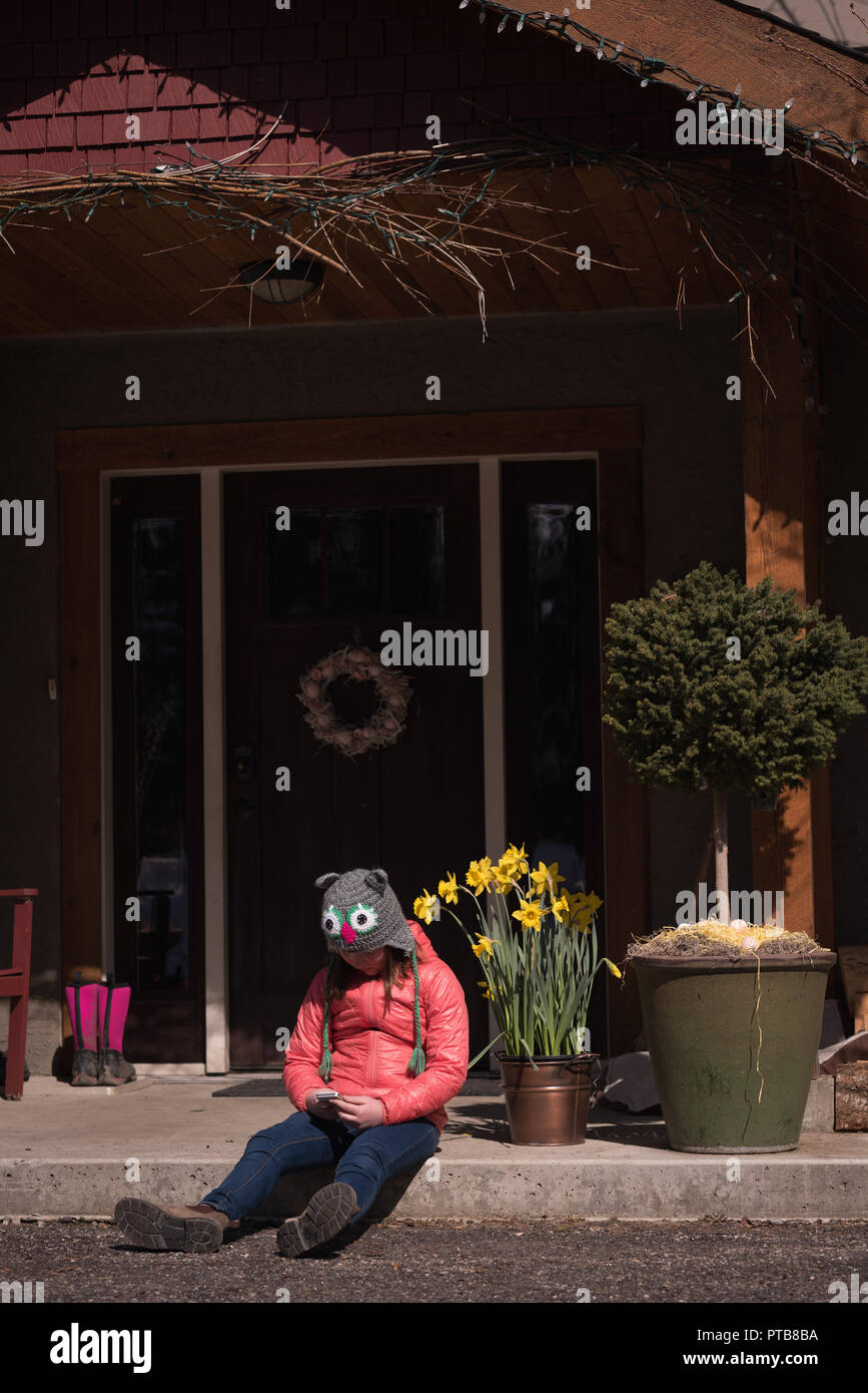 Girl using mobile phone near street Stock Photo - Alamy