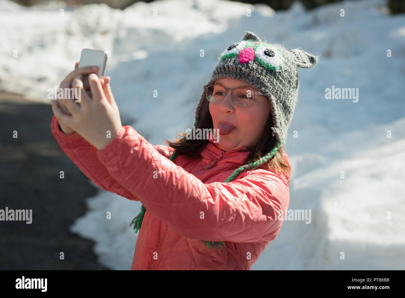 Girl using mobile phone near street Stock Photo - Alamy