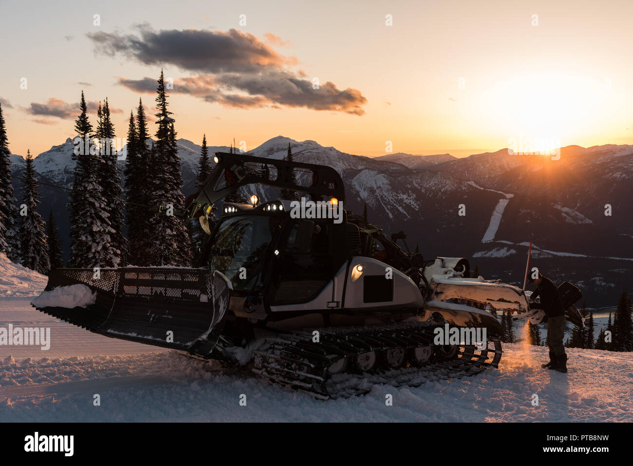Man cleaning snow from snowplow truck Stock Photo - Alamy