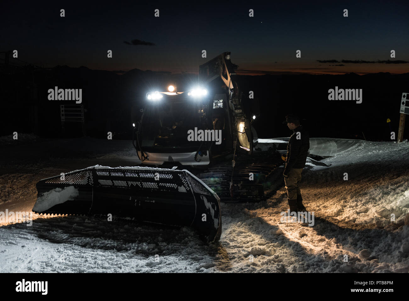 Man standing near snowplow machine Stock Photo - Alamy