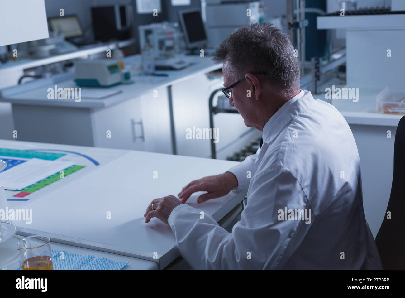 Male scientist using unseen new technology at desk Stock Photo - Alamy
