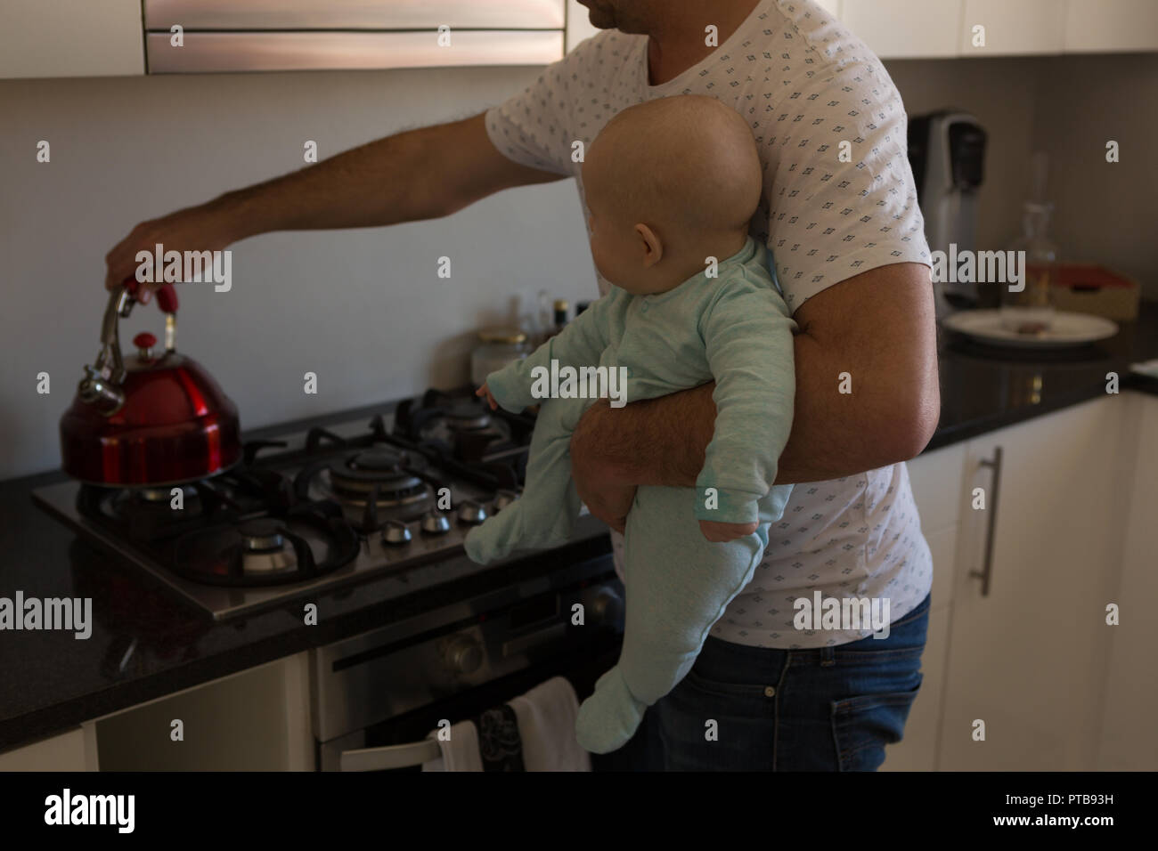 Father and baby boy preparing coffee in kitchen Stock Photo - Alamy