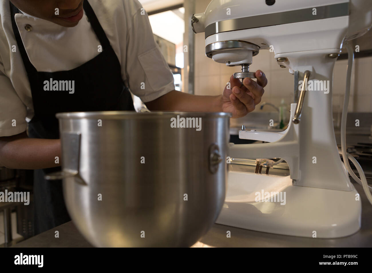 Female chef using kneading machine in kitchen Stock Photo - Alamy