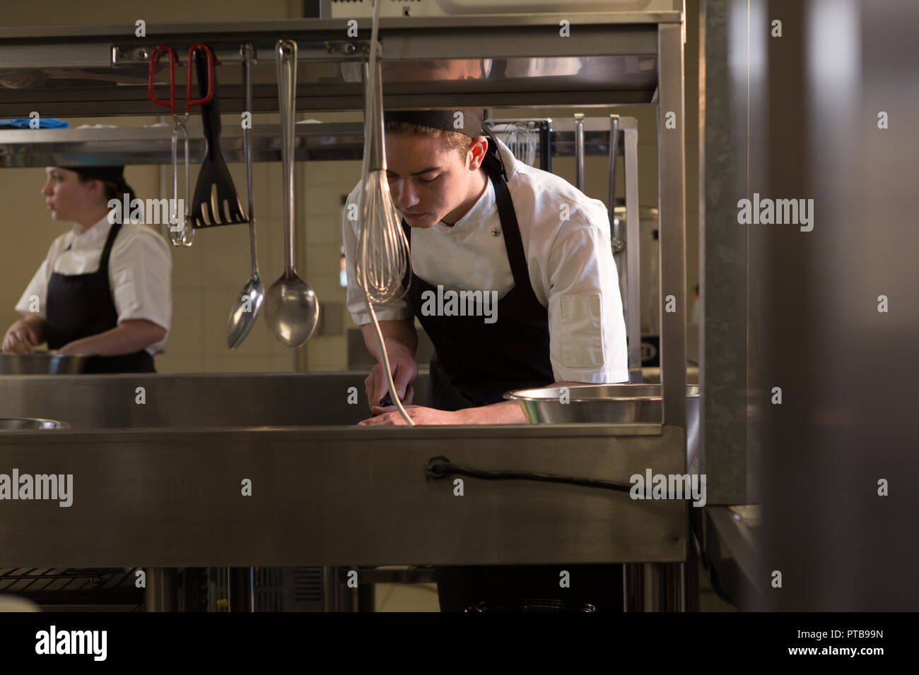 Male chef working in kitchen Stock Photo - Alamy
