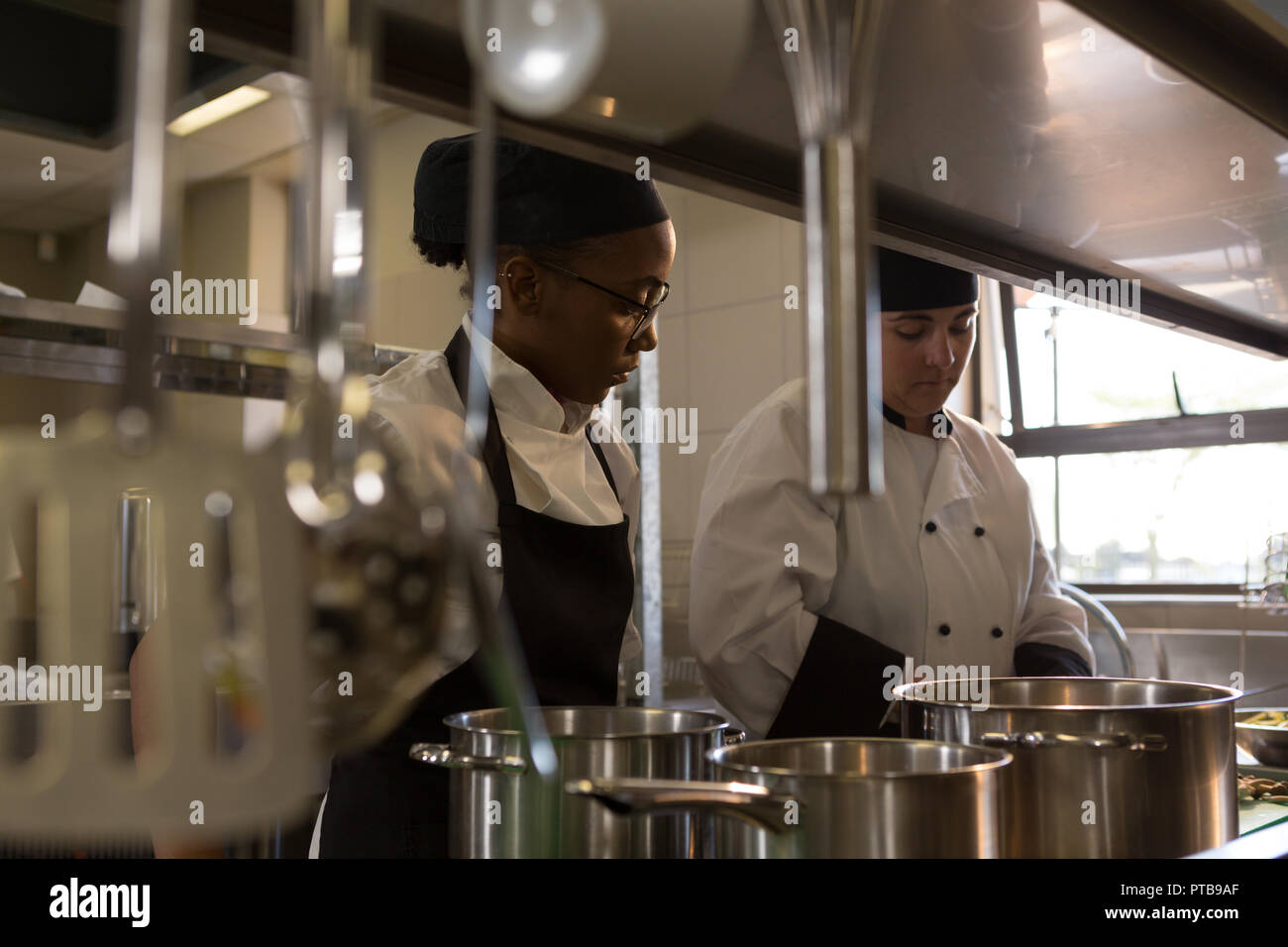 Female chefs working in kitchen Stock Photo - Alamy