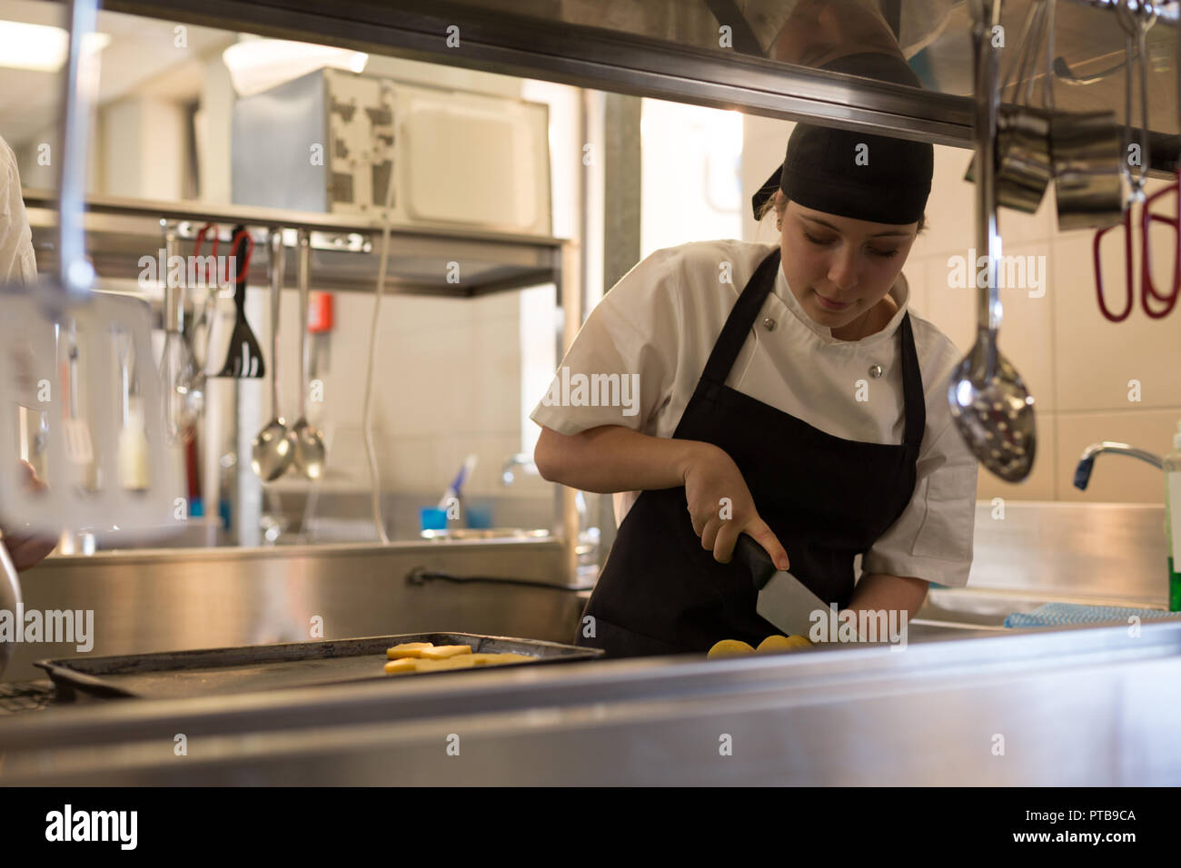 Female chef working in kitchen Stock Photo - Alamy