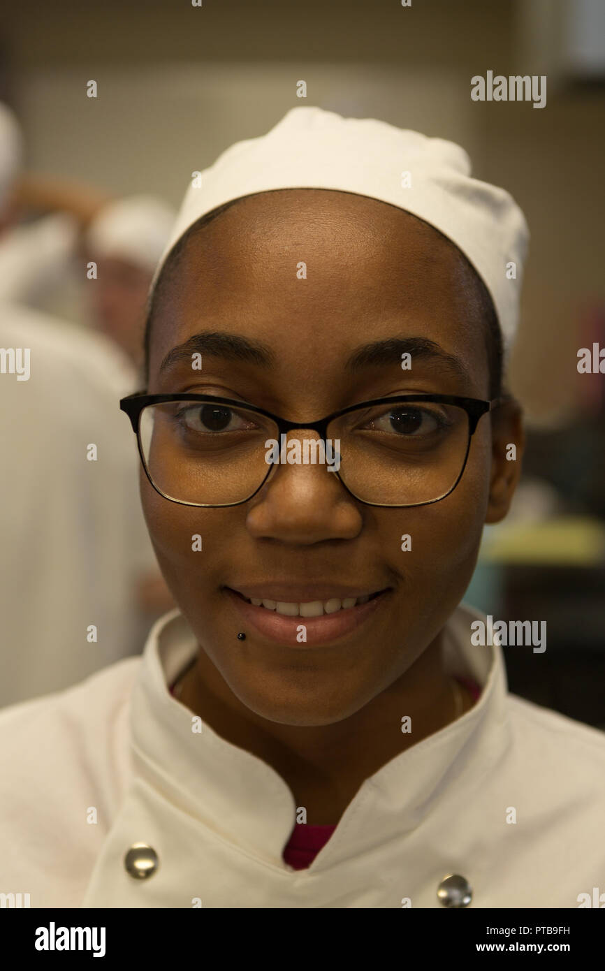 Female chef smiling in kitchen at restaurant Stock Photo - Alamy
