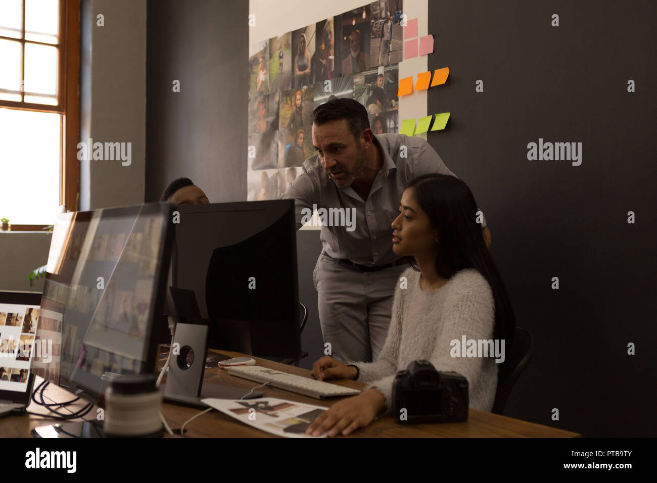 Business a man standing over a desk hi-res stock photography and images ...
