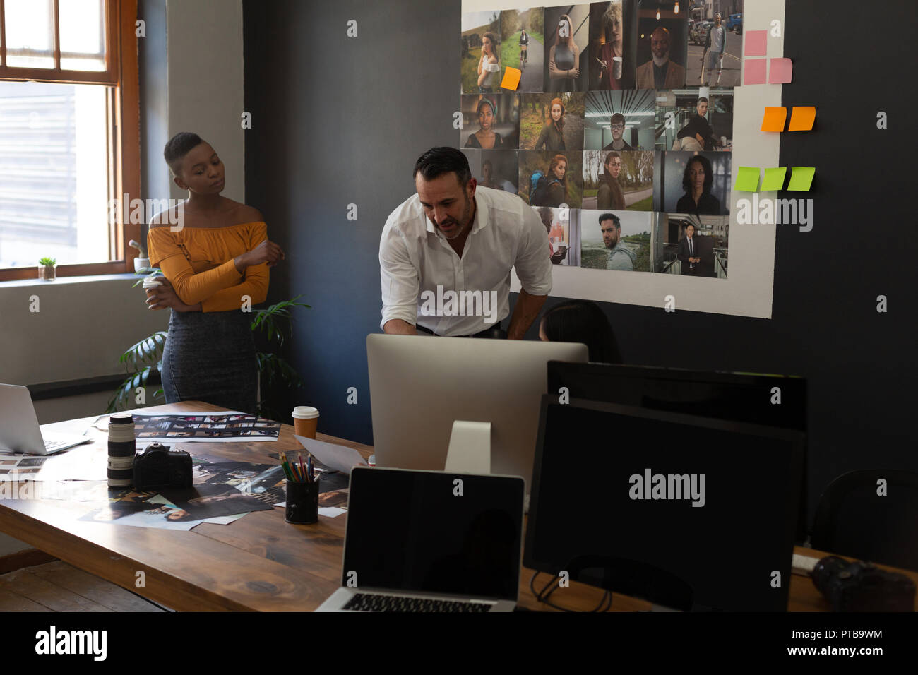 Business a man standing over a desk hi-res stock photography and images ...