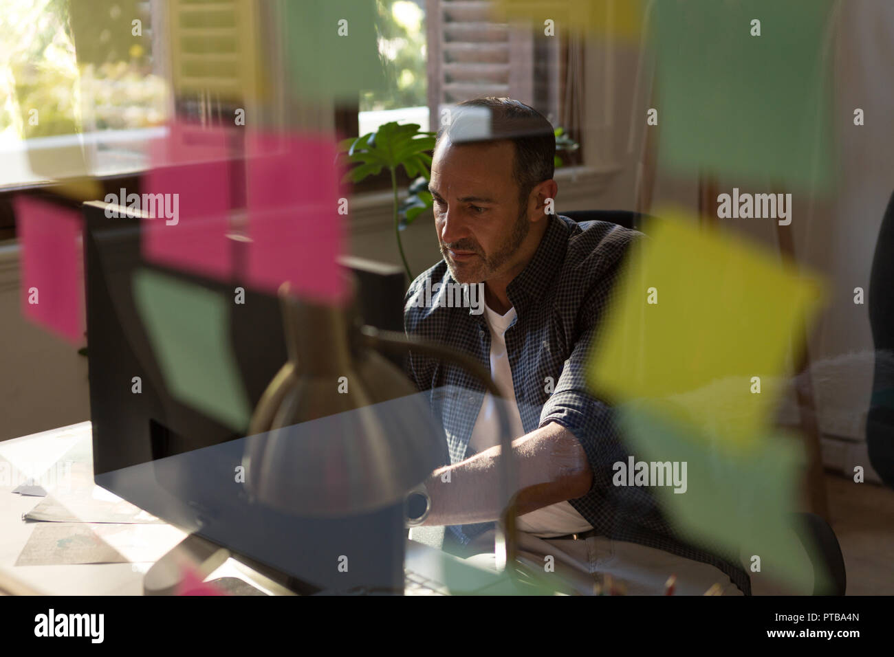 Male executive working on computer in office Stock Photo - Alamy
