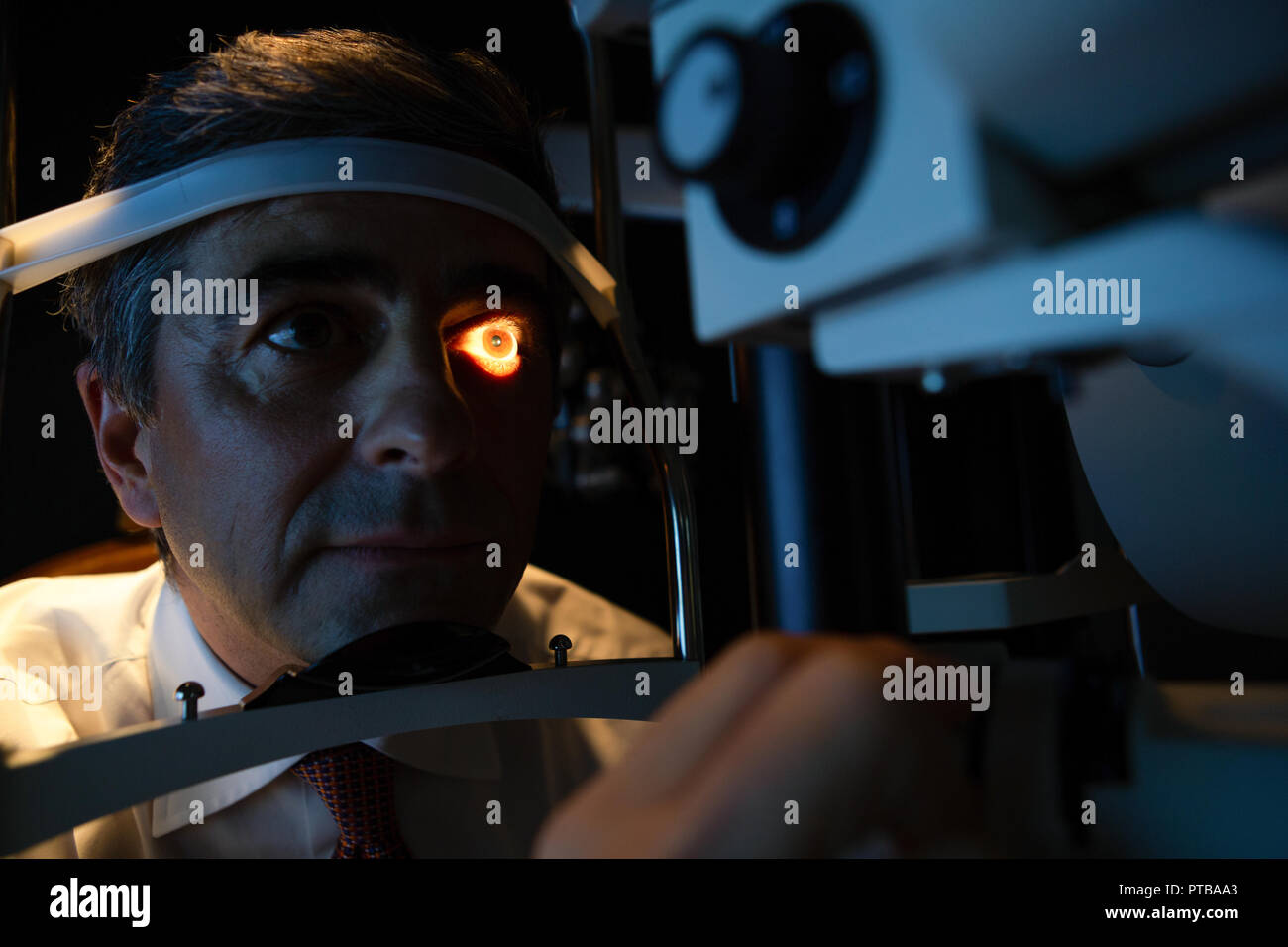 Optometrist examining patient eyes with slit lamp Stock Photo - Alamy