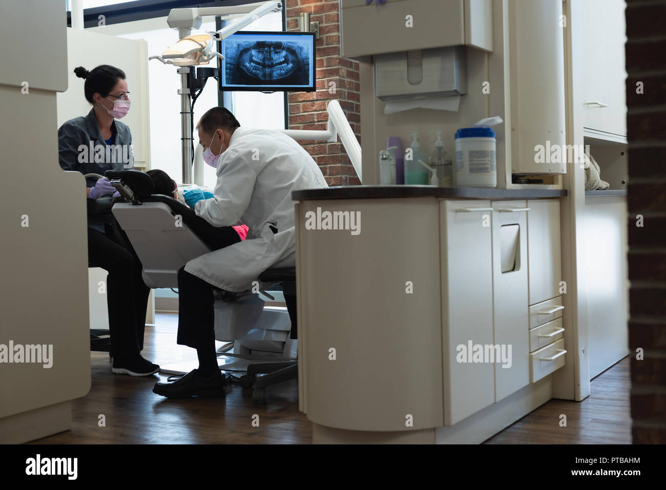 Dentist examining male patient tool hi-res stock photography and images ...
