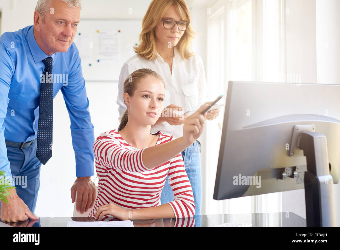 Young financial assistant businesswoman sitting in front of computer ...
