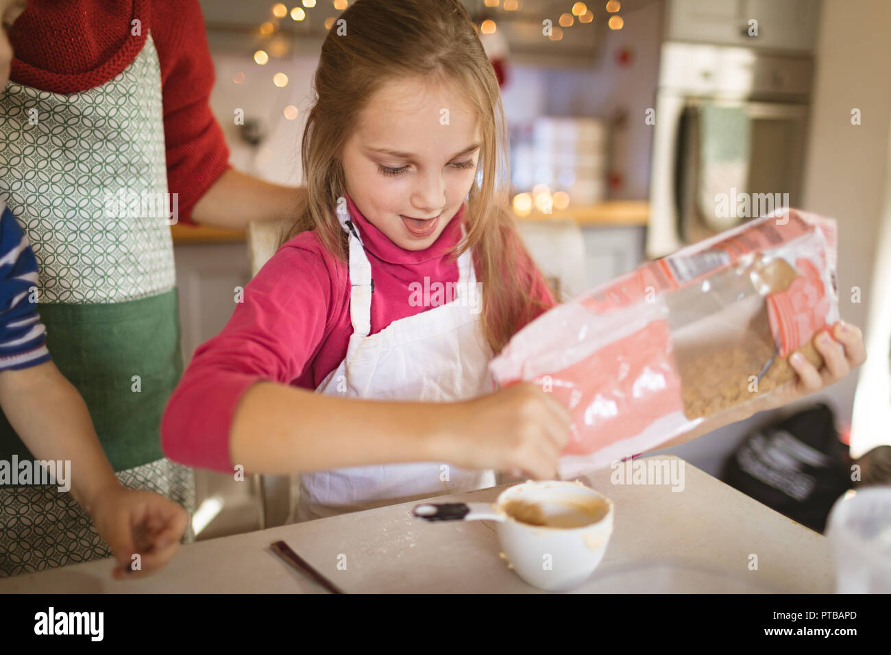 Girl pouring the ingredients into the cup Stock Photo - Alamy