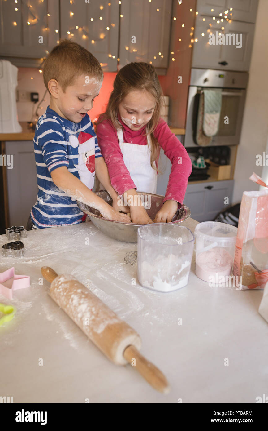 Siblings preparing batter in the kitchen Stock Photo - Alamy