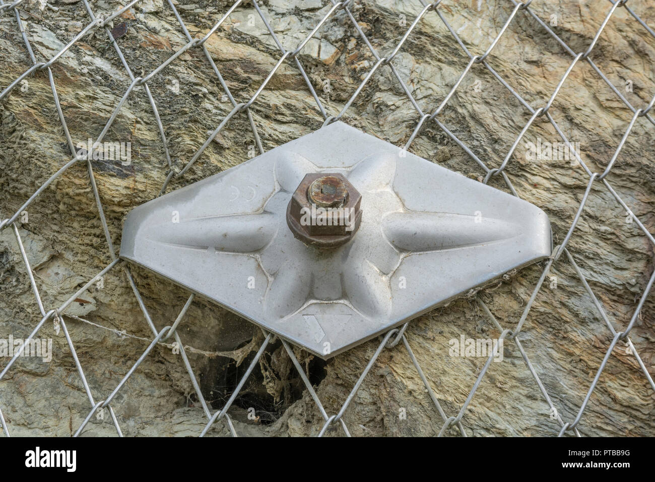 Chain link rockfall protection mesh and anchor point Stock Photo - Alamy