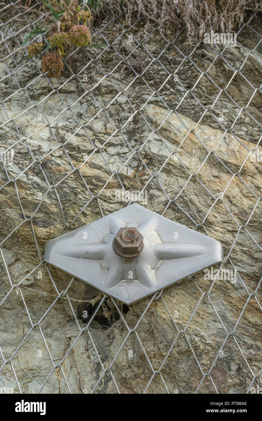 Chain link rockfall protection mesh and anchor point Stock Photo - Alamy