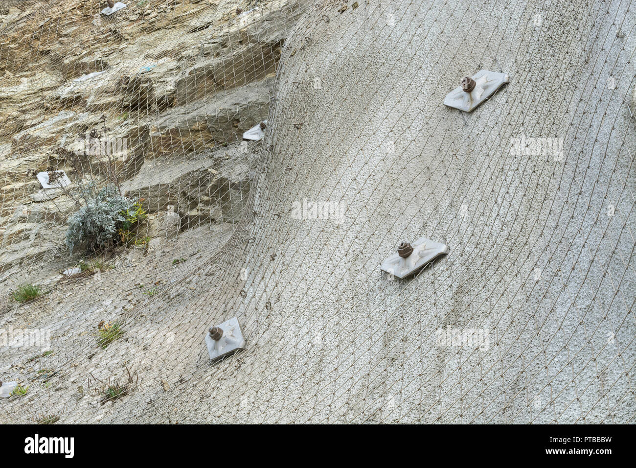 Chain link rockfall protection mesh and anchor point Stock Photo - Alamy
