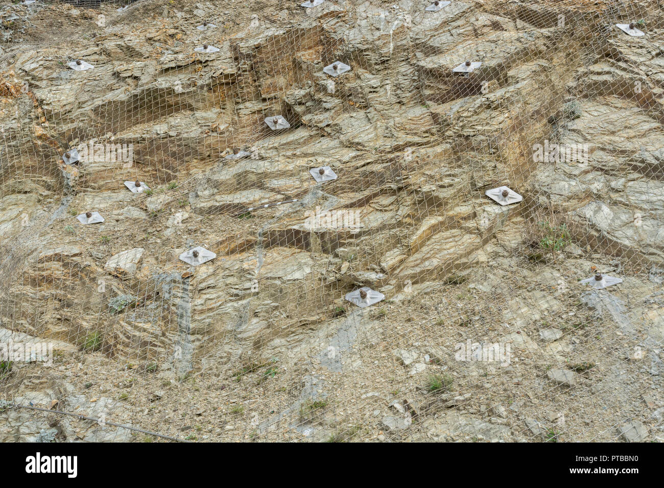 Chain link rockfall protection mesh and anchor point Stock Photo - Alamy