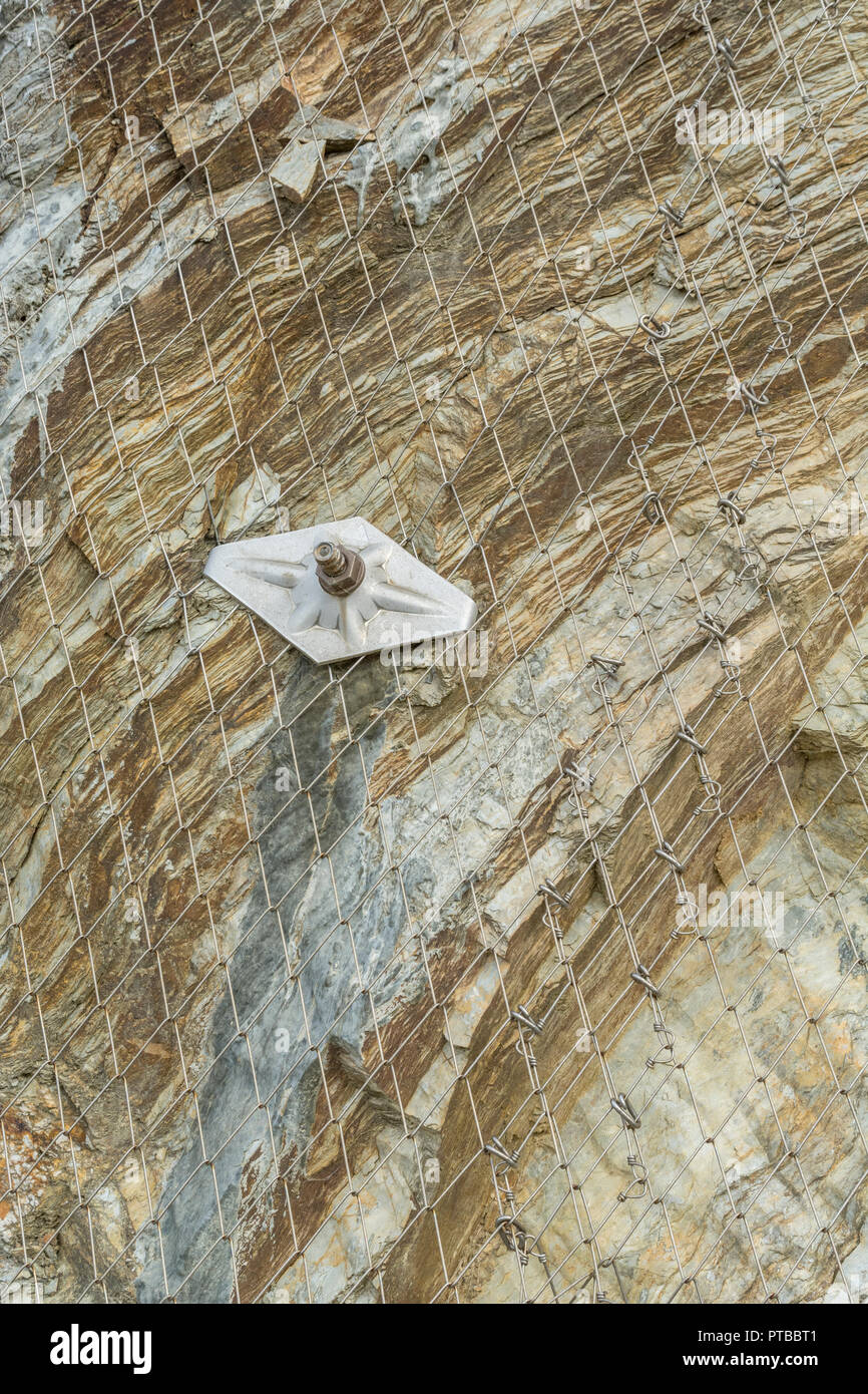 Chain link rockfall protection mesh and anchor point Stock Photo - Alamy