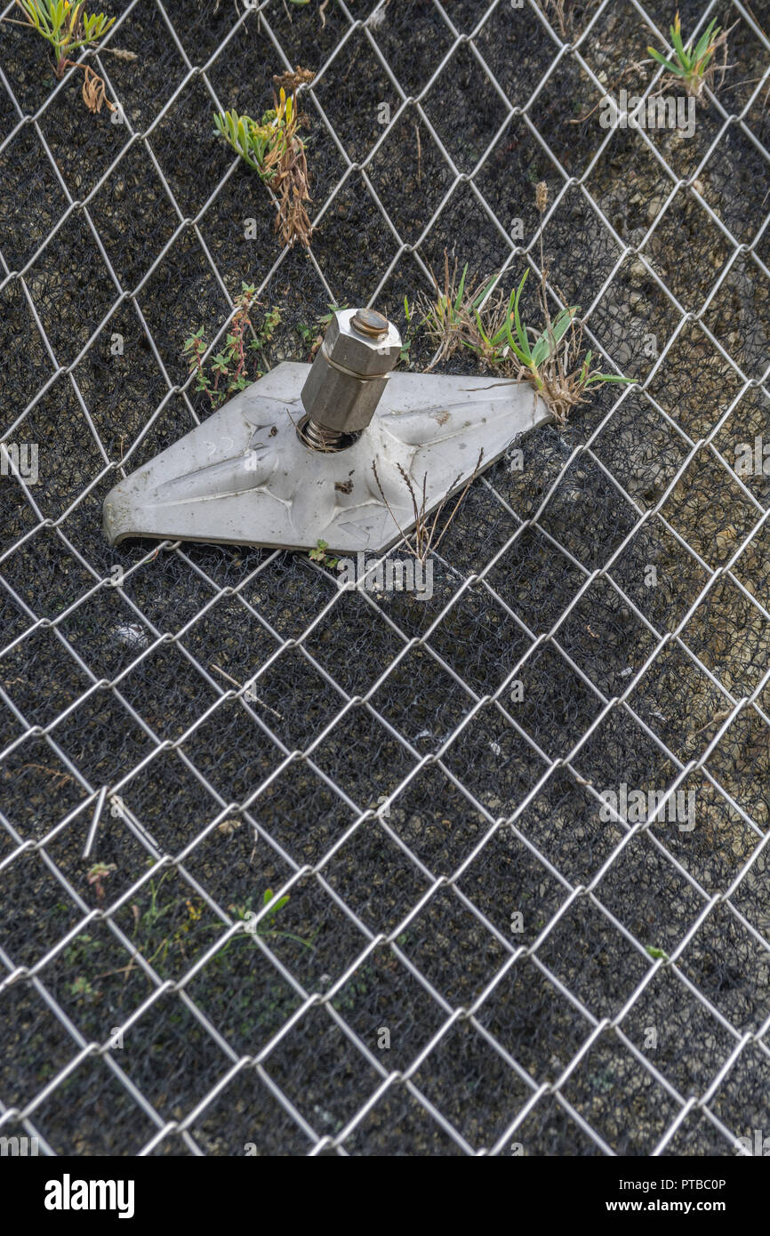 Chain link rockfall protection mesh and anchor point Stock Photo - Alamy