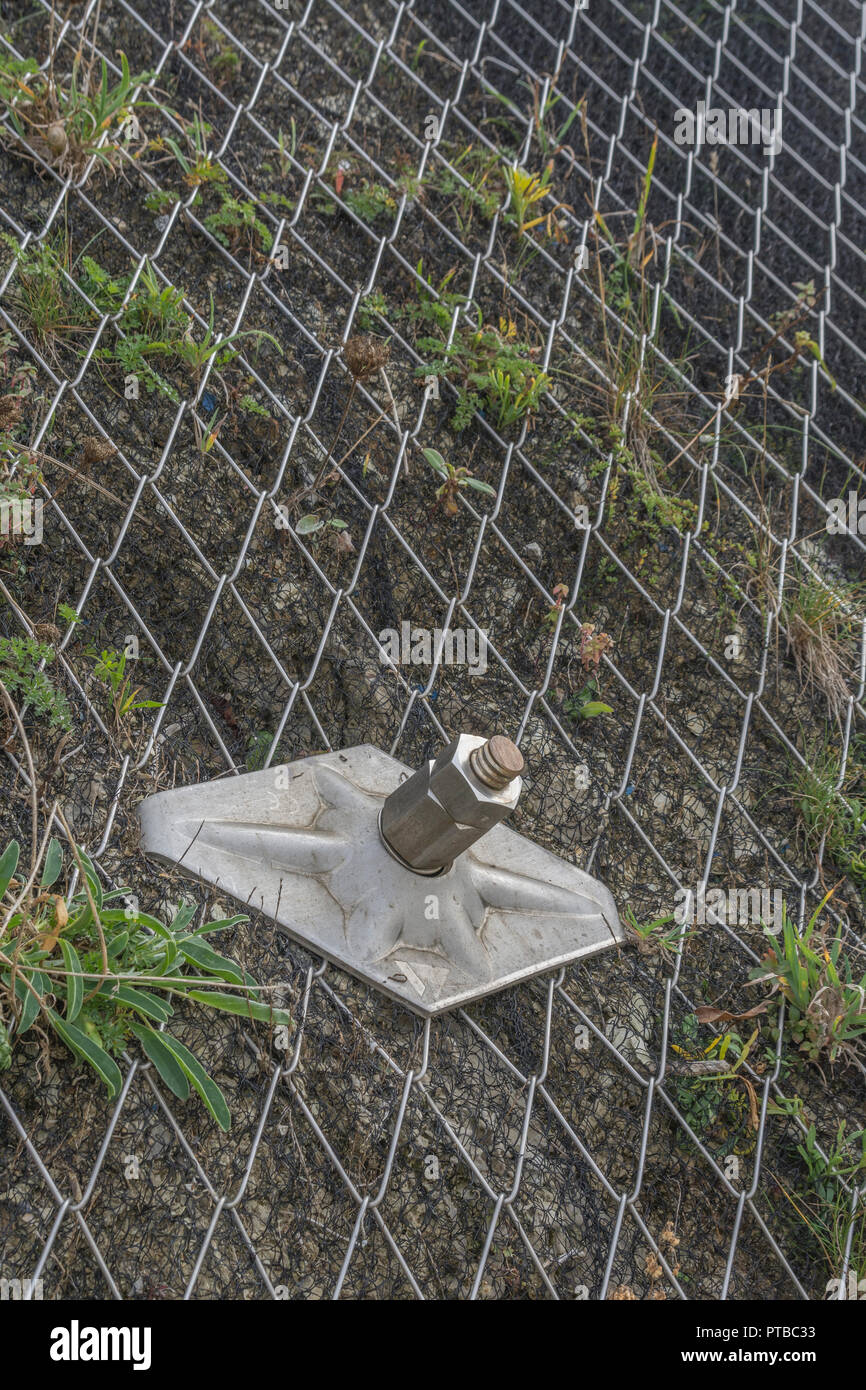 Chain link rockfall protection mesh and anchor point Stock Photo - Alamy