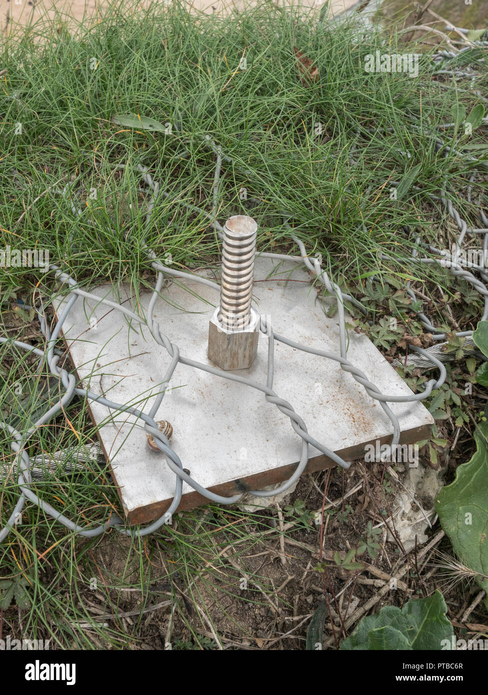 Chain link rockfall protection mesh and anchor point Stock Photo - Alamy
