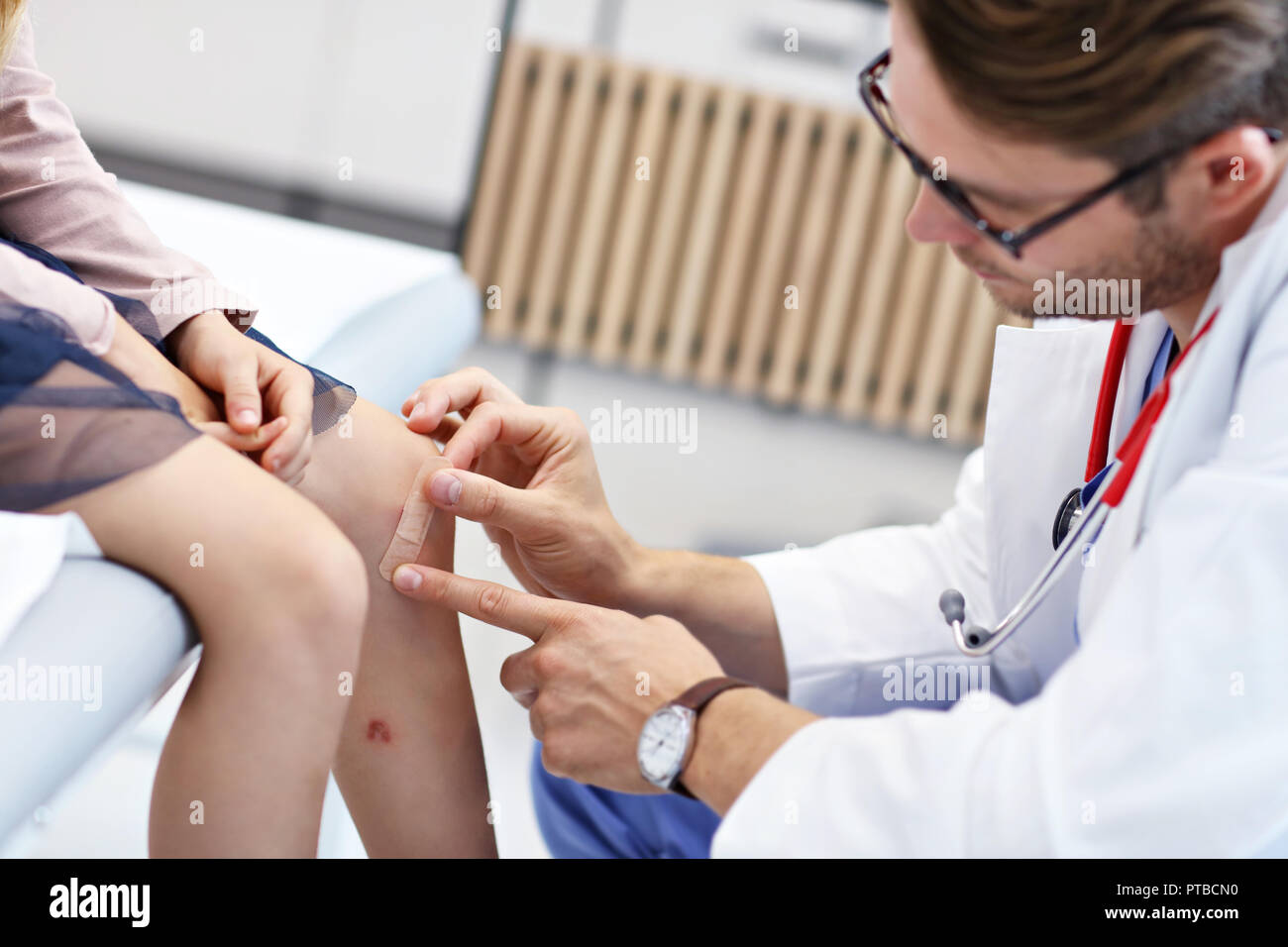 Picture showing little girl in clinic being examined by dermatologist ...
