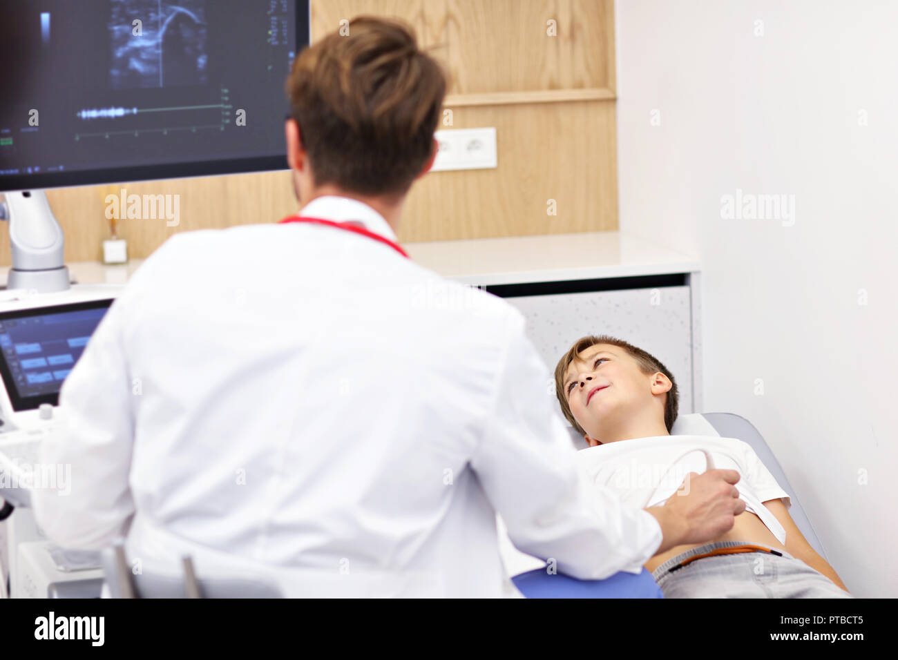 Picture of male doctor testing young boy with usg Stock Photo - Alamy
