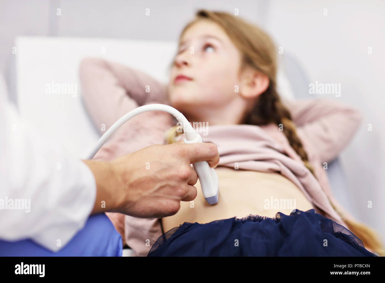 Picture of male doctor testing young girl with usg Stock Photo - Alamy
