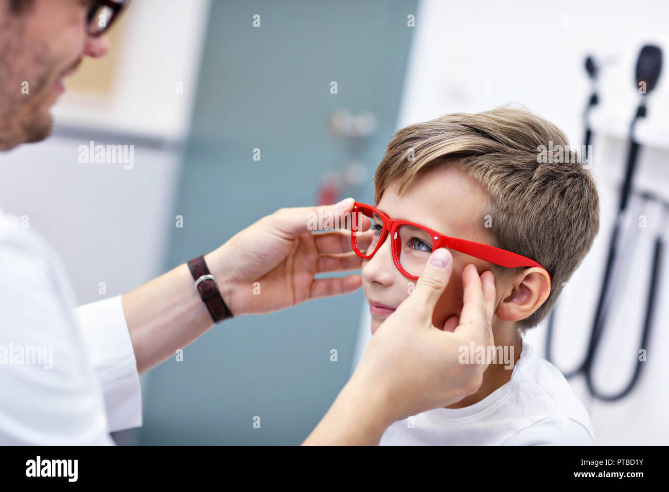 Picture of child optometry male optometrist optician doctor examines ...