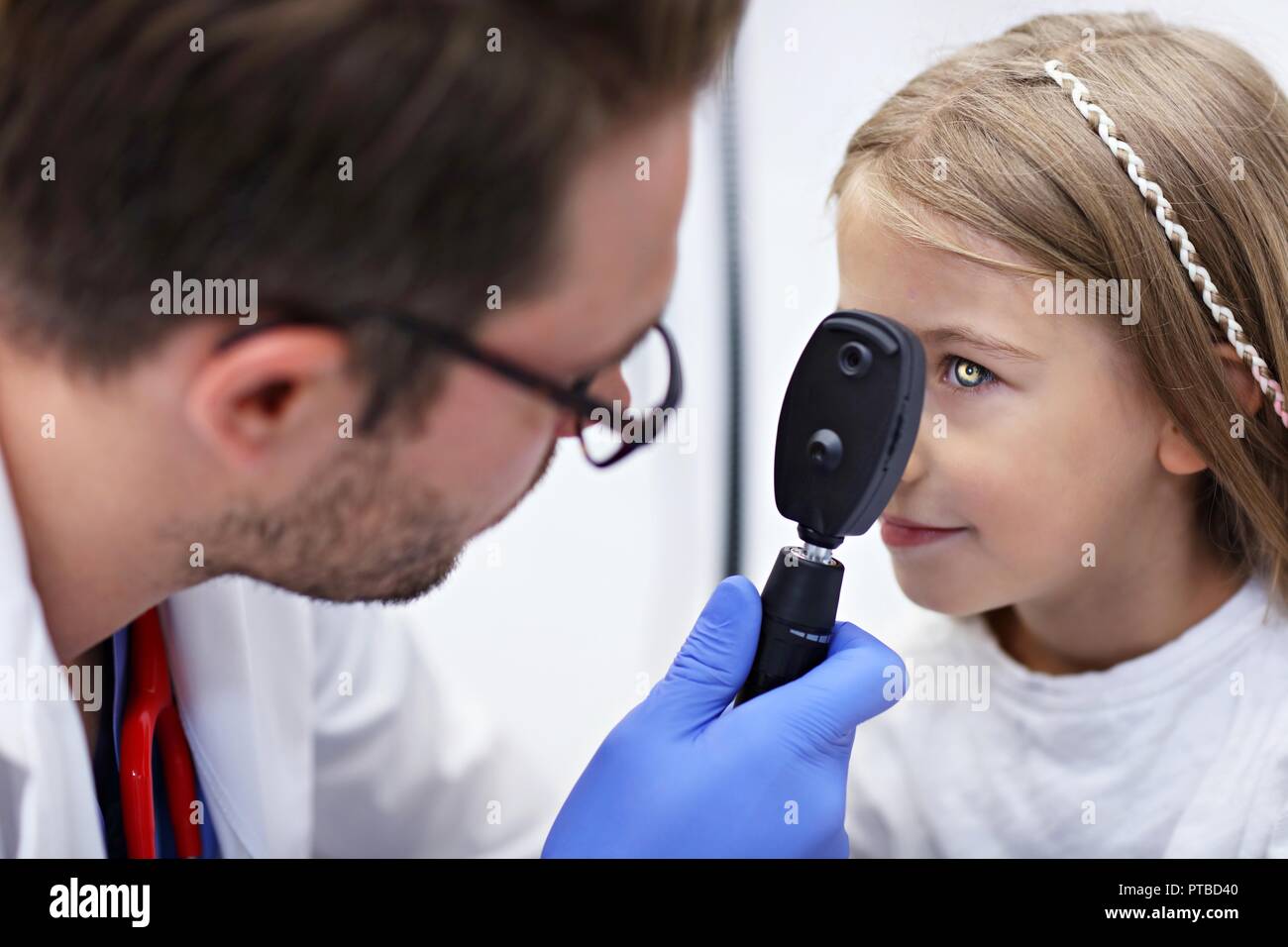 Picture of child optometry male optometrist optician doctor examines ...