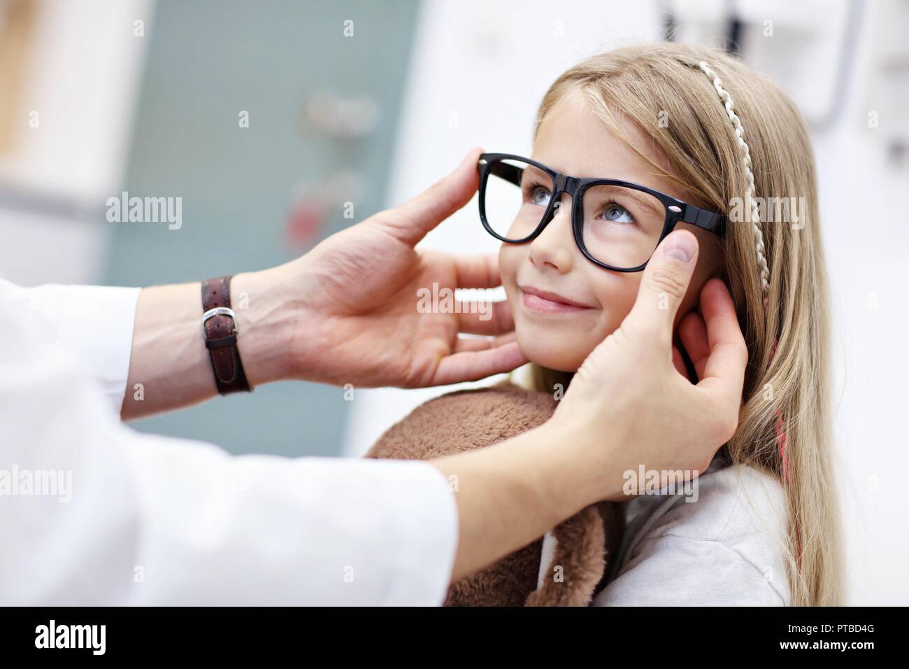 Picture of child optometry male optometrist optician doctor examines ...
